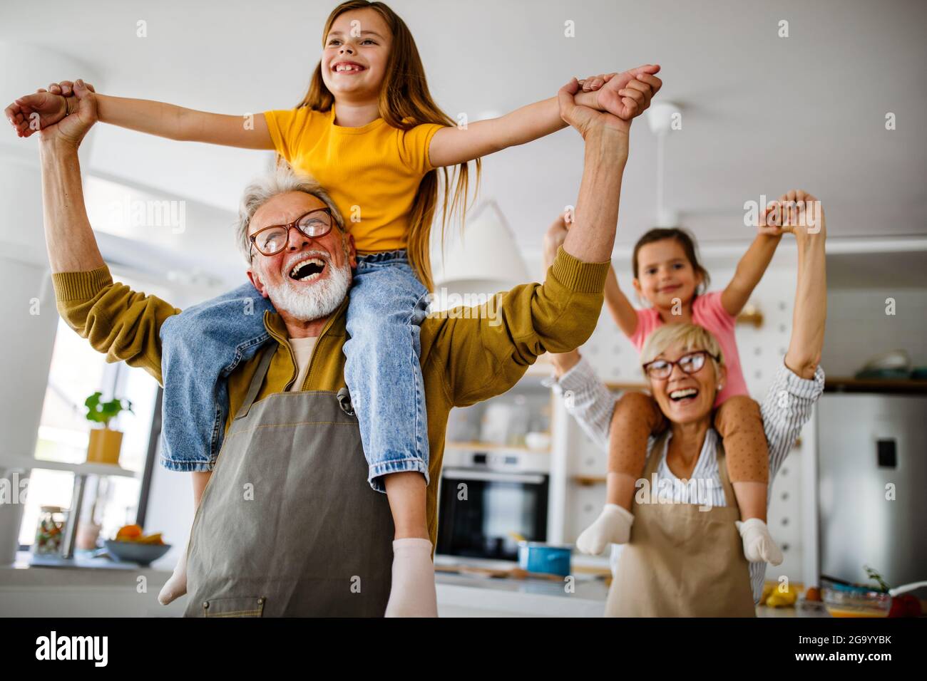 Grandchildren having fun, playing with grandparents at home Stock Photo ...