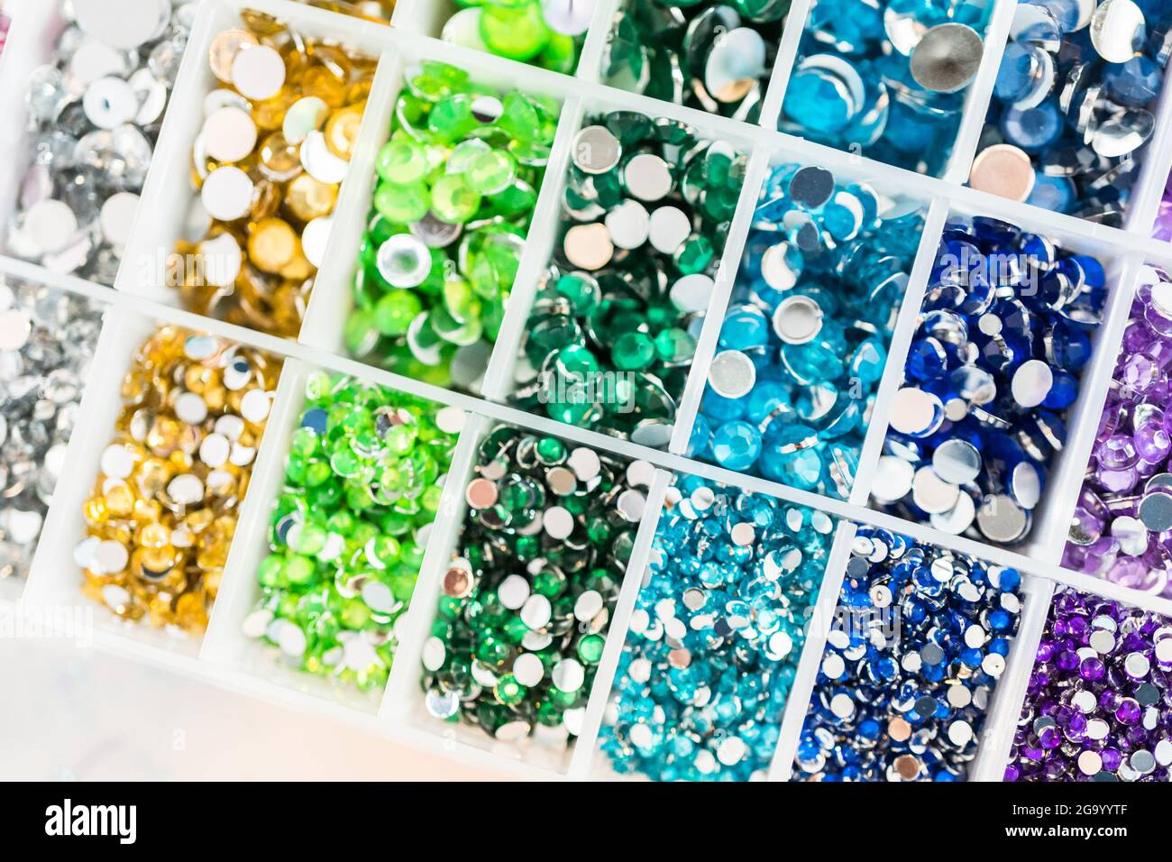 Color and size variety of rhinestones in the craft box Stock Photo - Alamy