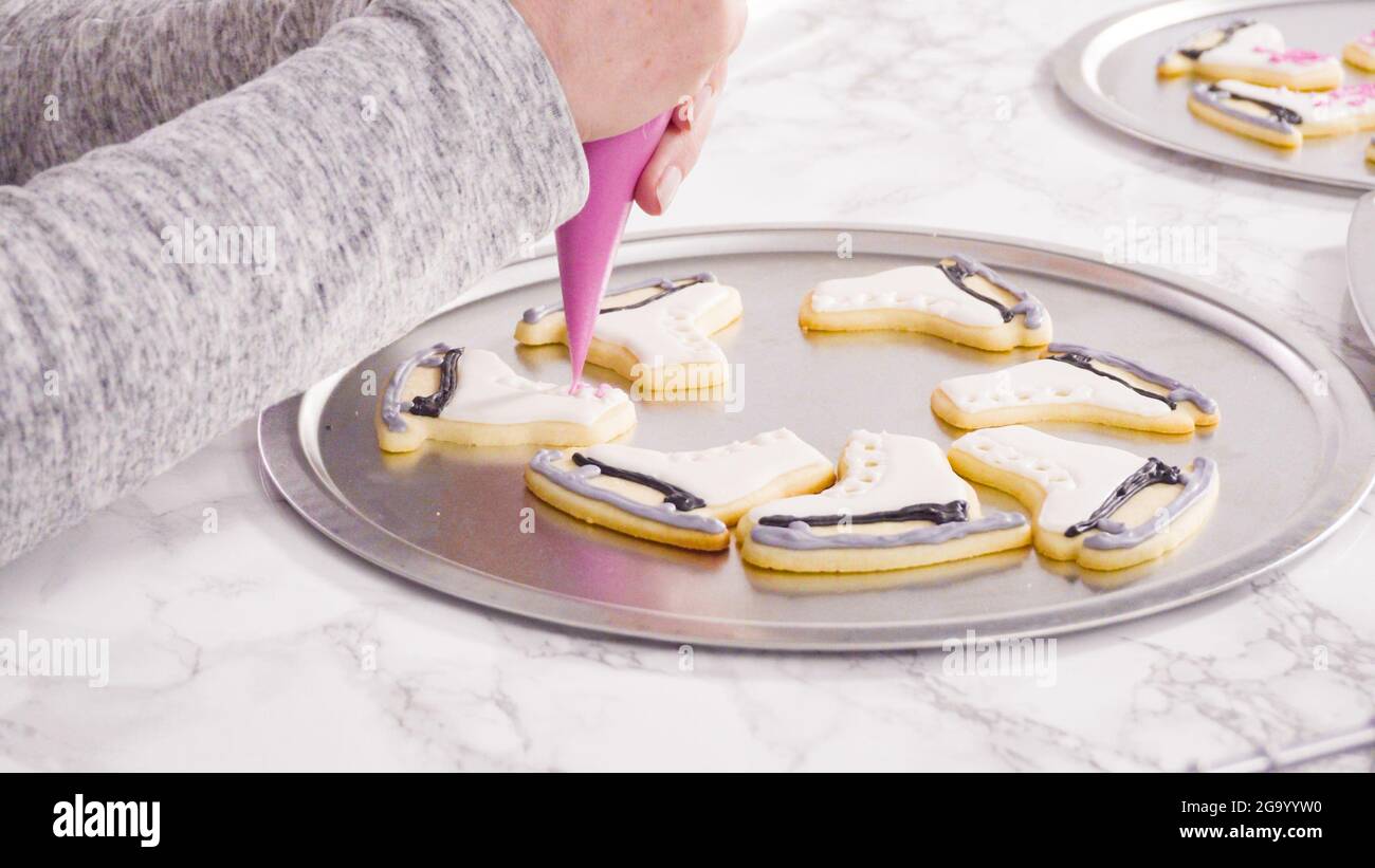 Icing figure skate shaped sugar cookies with royal icing Stock Photo ...