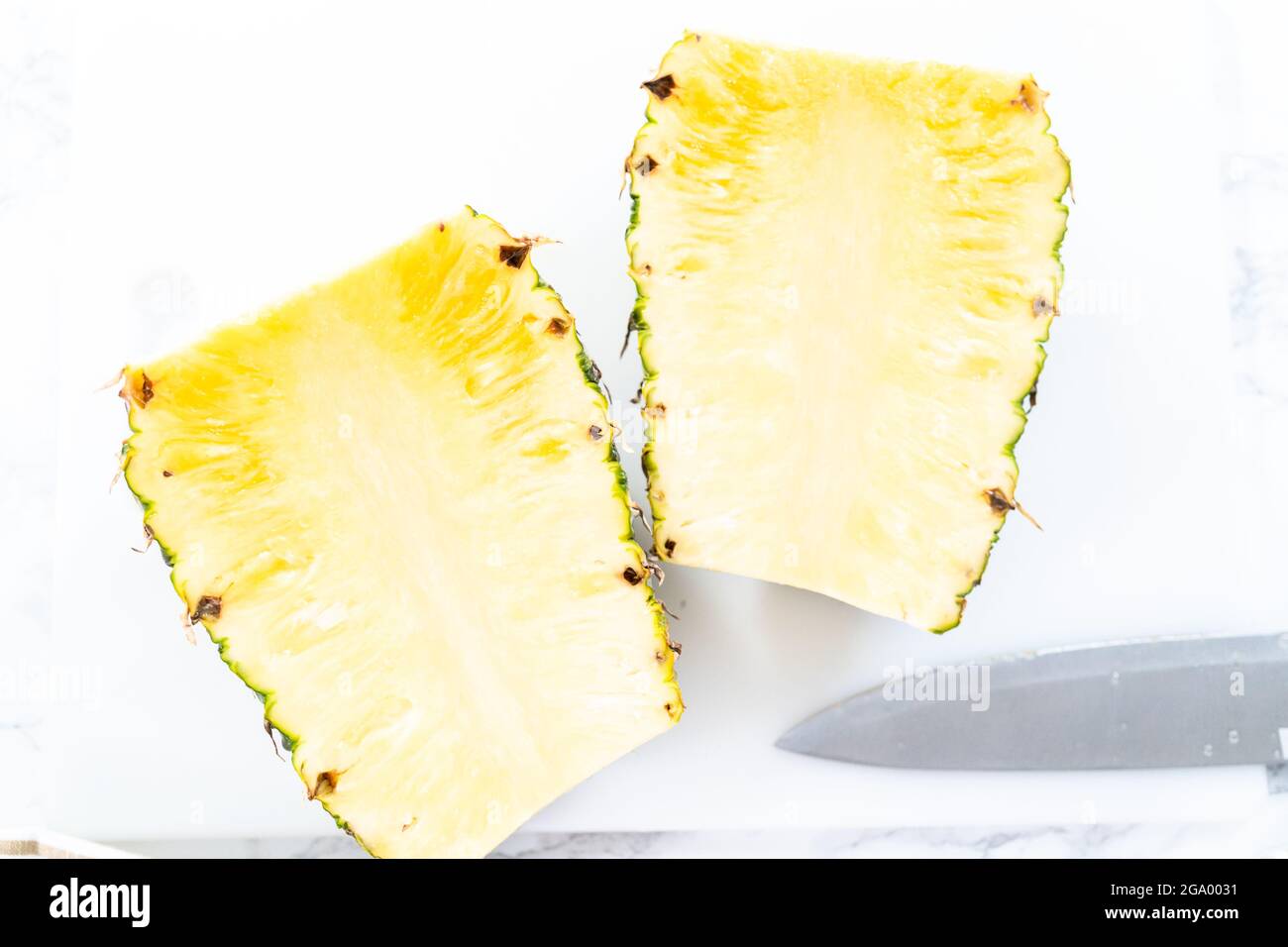 Cleaning and cutting a pineapple into the small pieces Stock Photo - Alamy