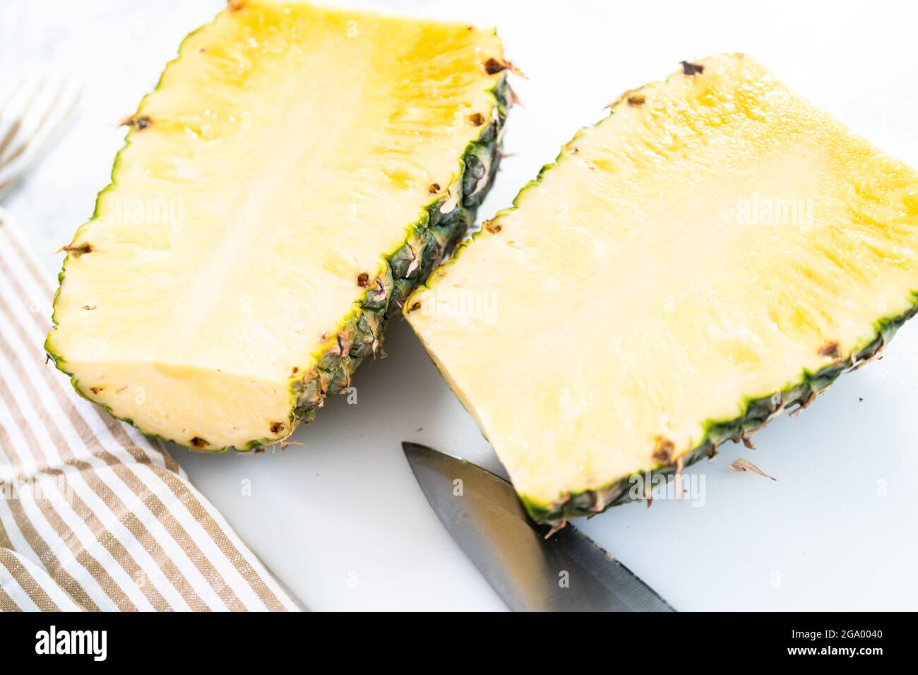 Cleaning and cutting a pineapple into the small pieces Stock Photo - Alamy