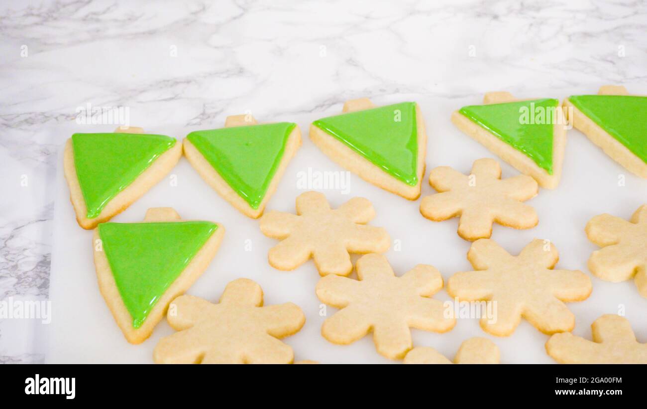 Stp by step. Icing Christmas tree-shaped sugar cookies with green royal ...