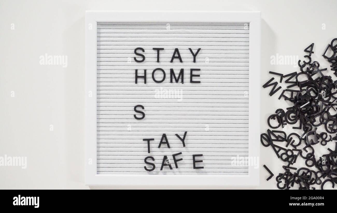 Flat lay. STAY HOME and STAY SAFE sign on a white message board Stock ...