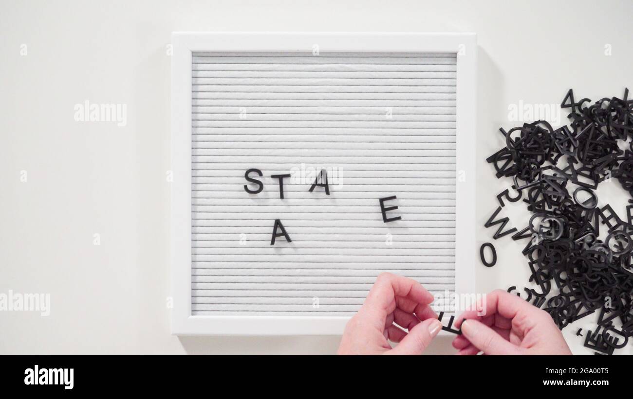 Flat lay. STAY HOME and STAY SAFE sign on a white message board Stock ...