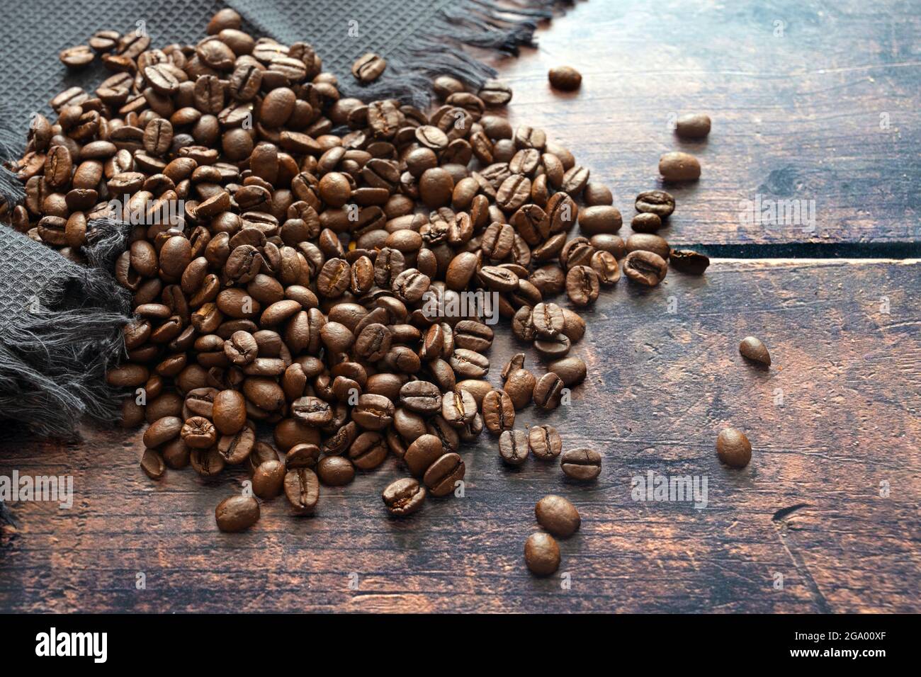 Roasted coffee beans on rustic wood for a fragrant and aromatic hot ...