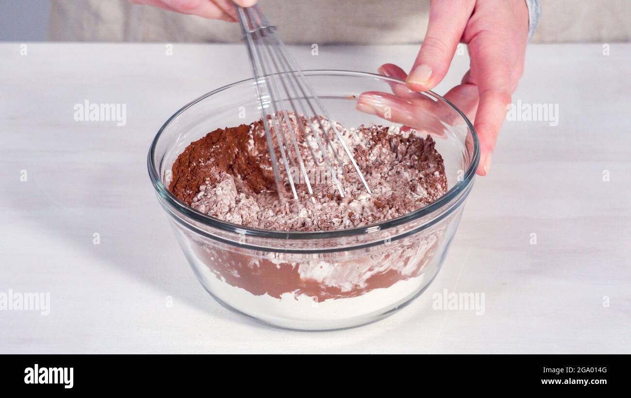 Step by step. Mixing ingredients in a glass mixing bowl to bake ...