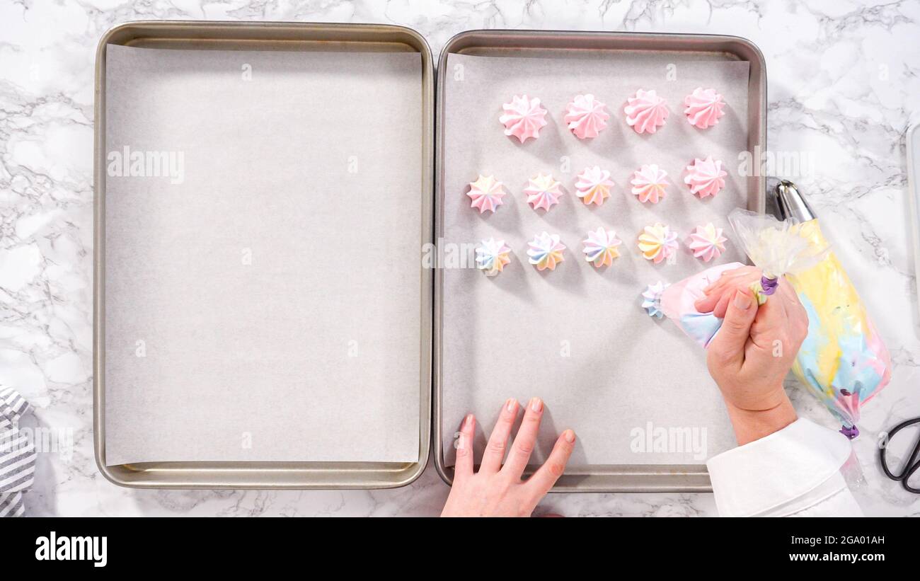 Step by step. Flat lay. Piping unicorn meringue cookies to the baking ...