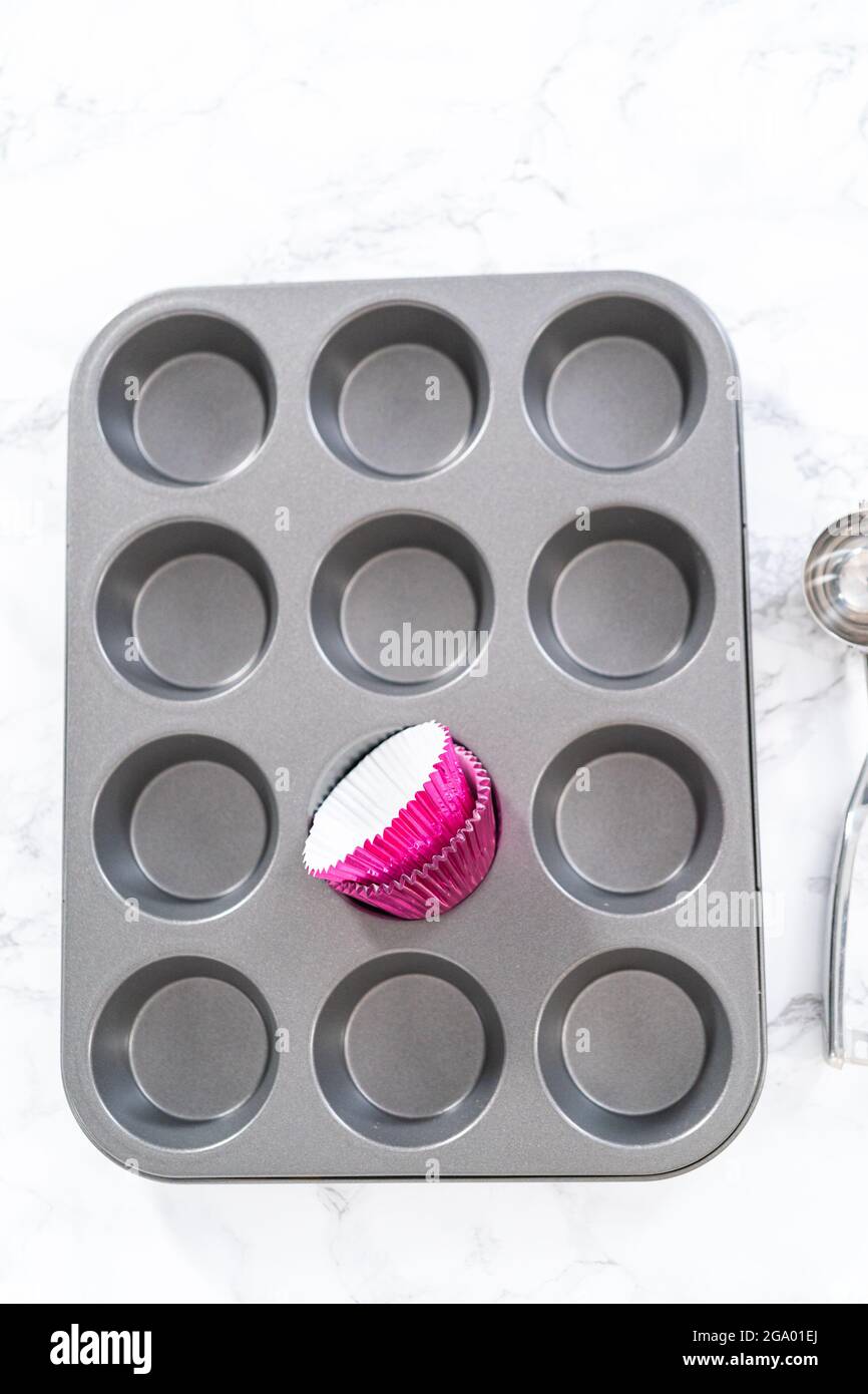 Baking chocolate cupcakes. Lining metal cupcake pan with foil cupcake ...
