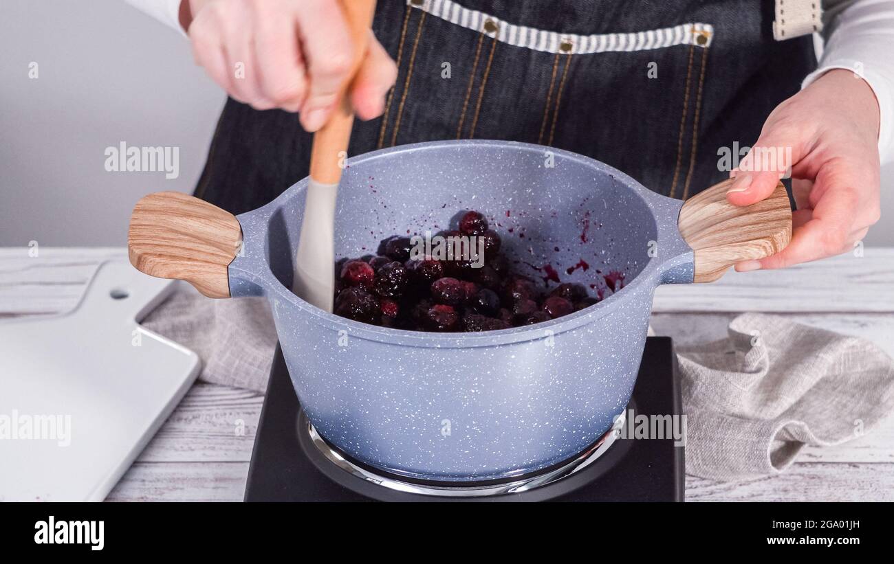 Step by step. Preparing mixed berry compote from frozen berries in a ...