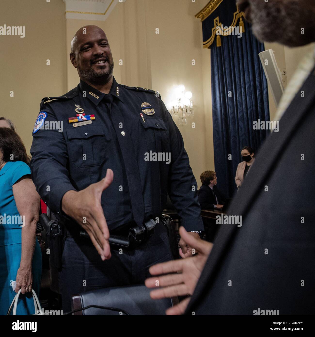 WASHINGTON, DC - JULY 27: Capitol Police officer Harry Dunn reaches out ...