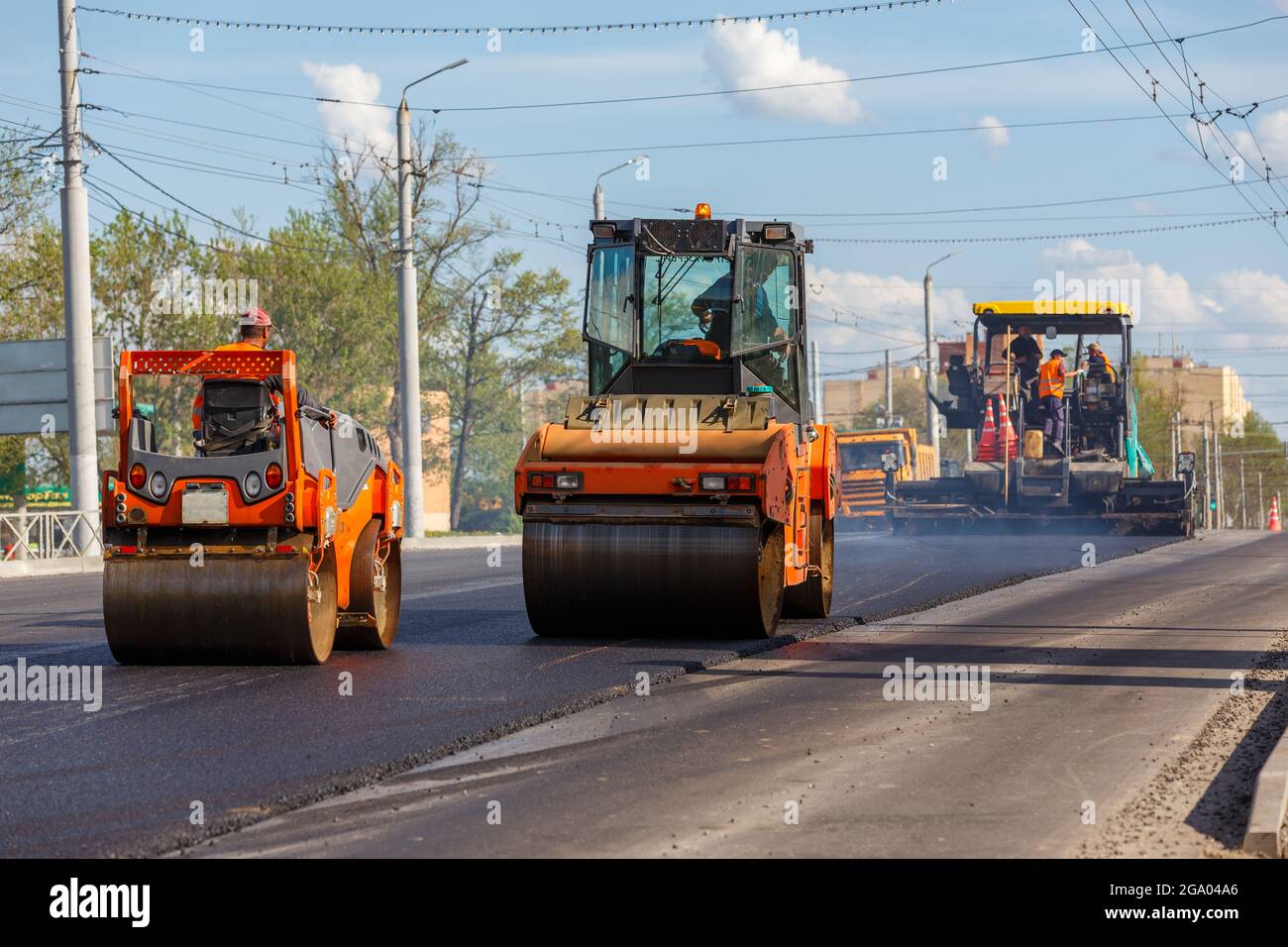 Process of asphalting, asphalt paver machine and two road rollers ...