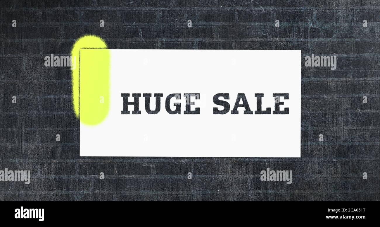 Huge sale stencil painted in green on brick wall 4k Stock Photo - Alamy