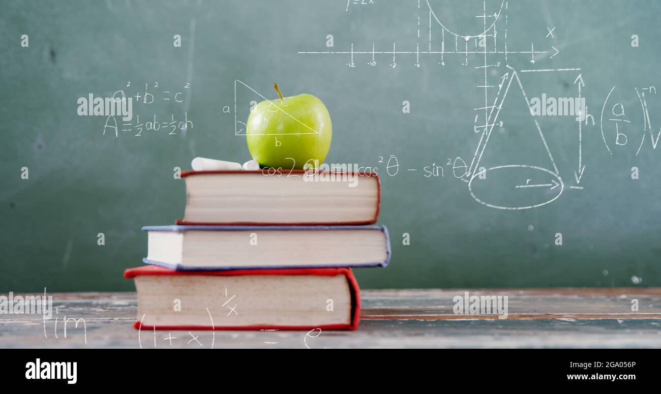 Mathematical equations floating against apple on stack of books Stock ...