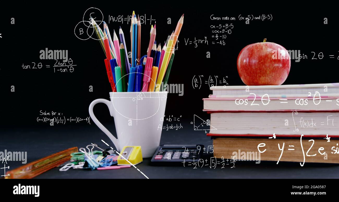 Mathematical equations floating against apple on stack of books and ...