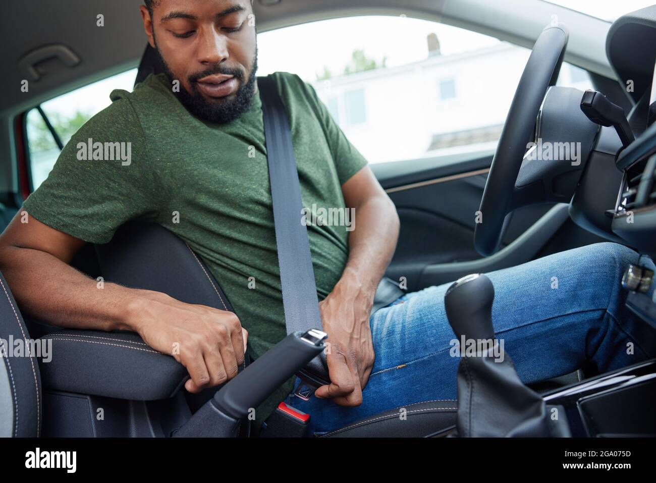Male Driver In Car Fastening Seatbelt Before Setting Off On Journey ...