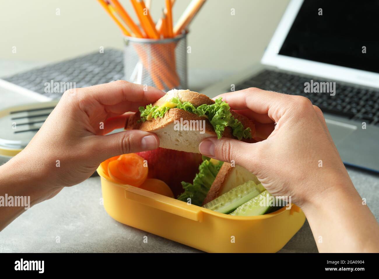 Workplace eating with female hands hold sandwich, close up Stock Photo ...