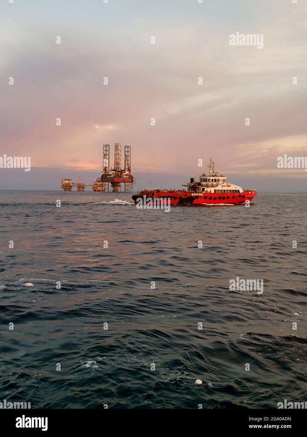 Marine crew working on deck during anchor handling operation near hi ...