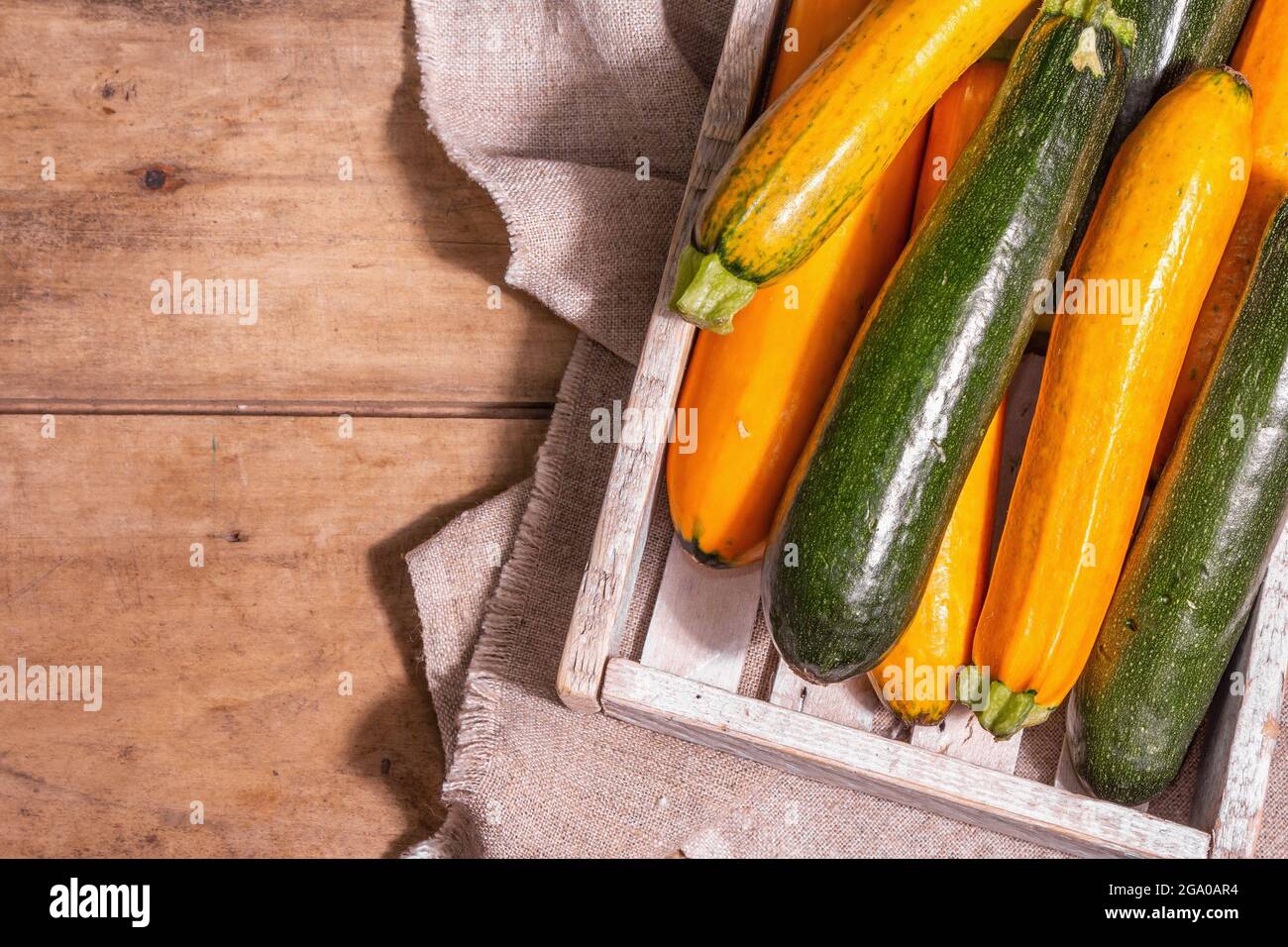 Assorted fresh zucchini. Ripe vegetables harvest in a wooden box ...
