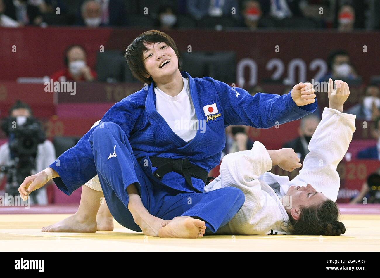 Chizuru Arai of Japan (blue) reacts after winning the women's judo 70 ...