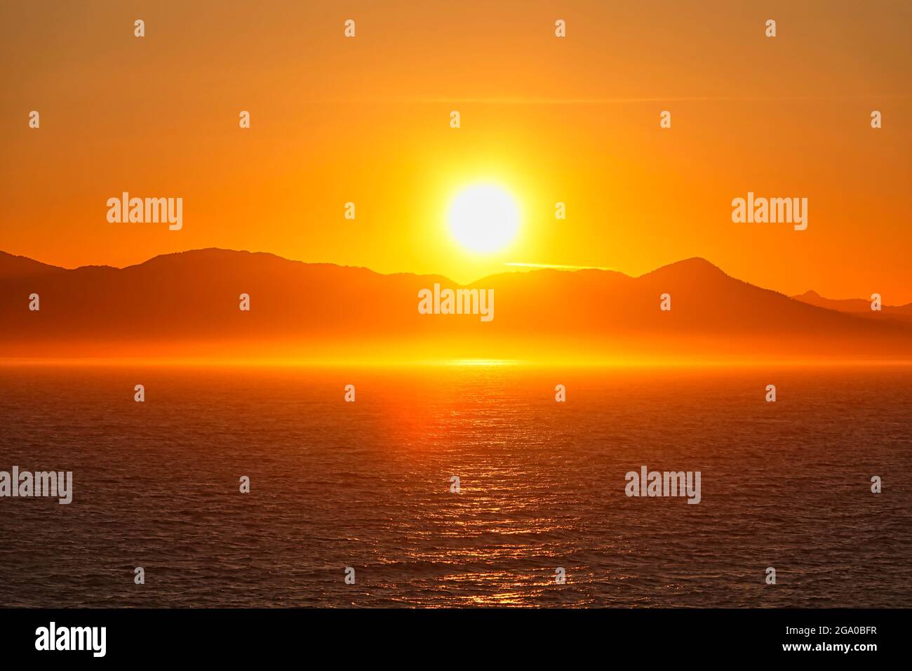 Beautiful golden sunset over the lake. Orange light in front of the ...