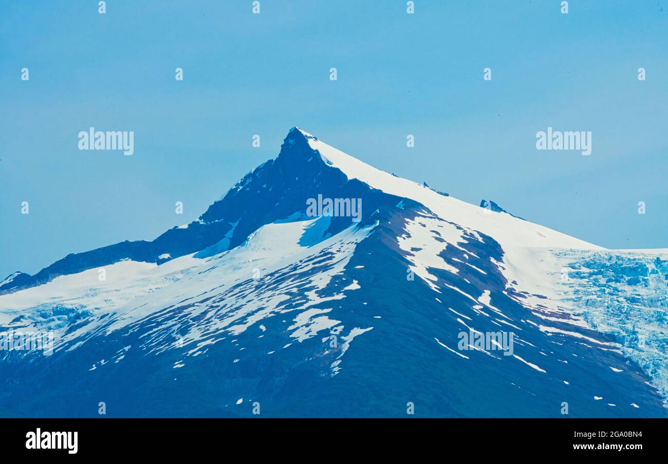 The top of the mountain is shaped like a pyramid. It is covered with ...