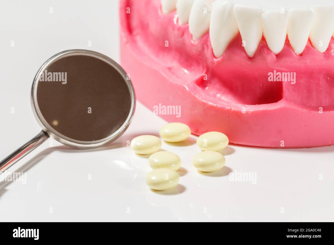 Layout of the human jaw, pills and a metal examination mirror. Layout ...