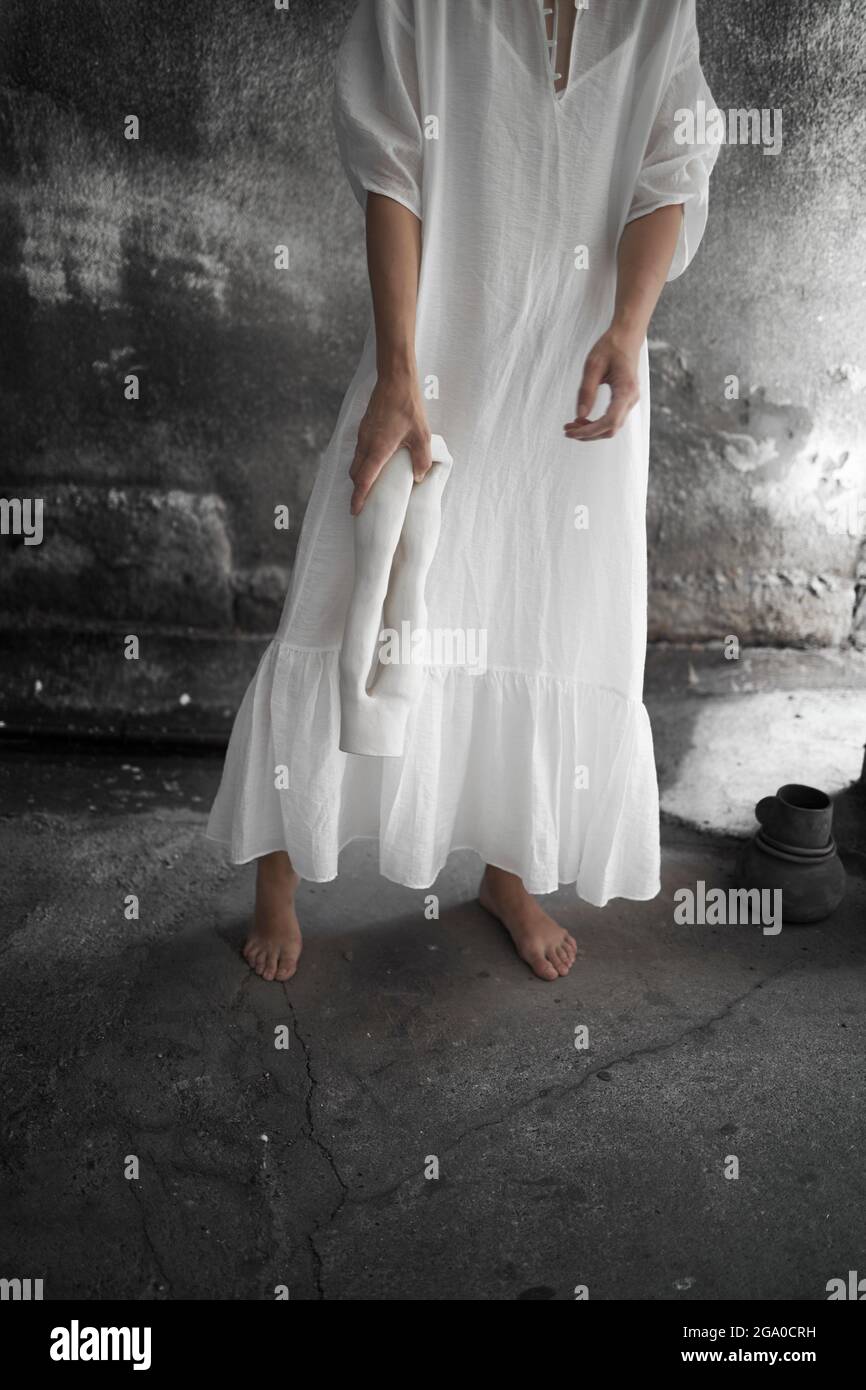 Female artist in a traditional dress holding her artwork Stock Photo ...