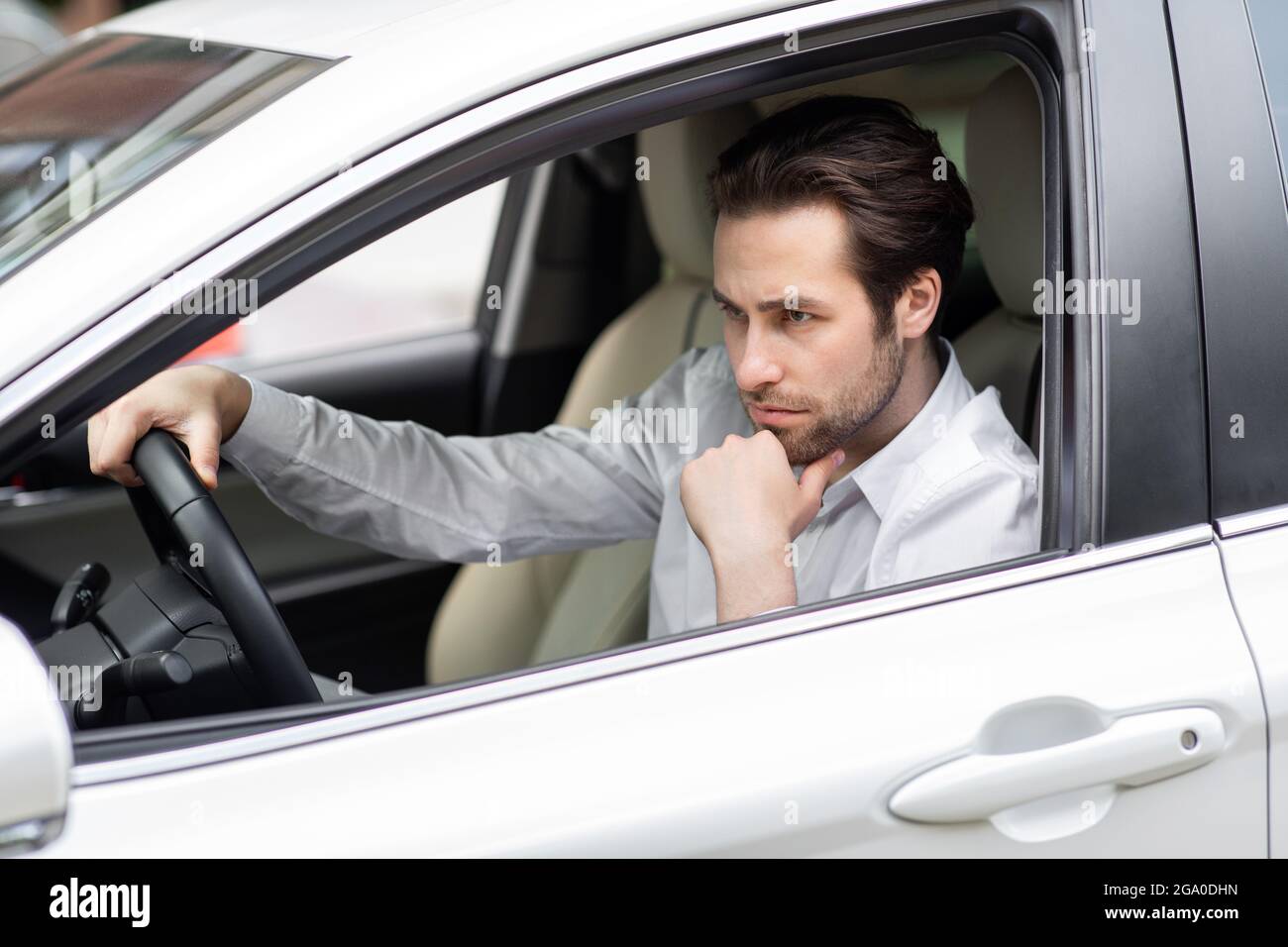Annoyed tired young man riding driving car. Businessman late for ...