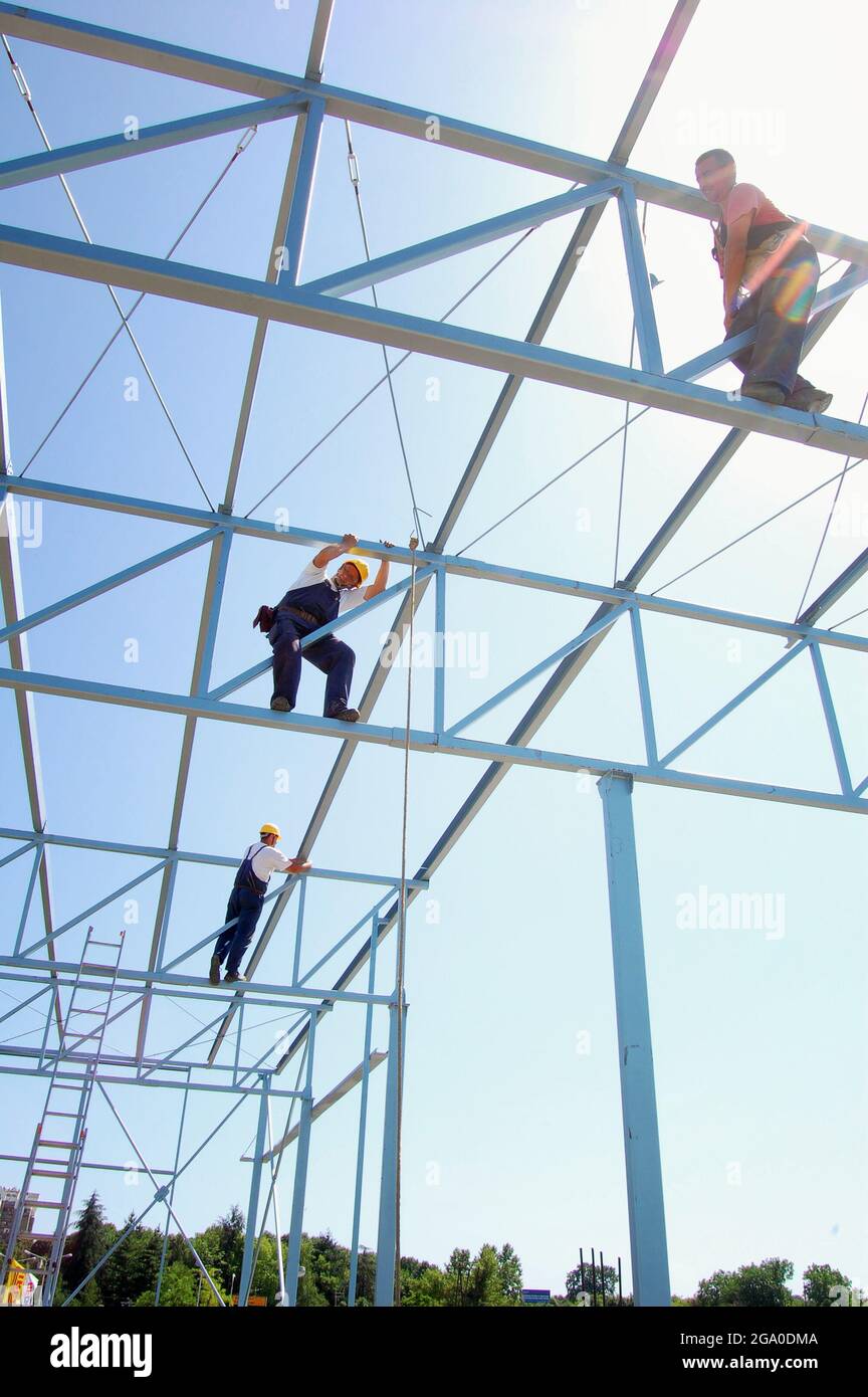 Iron Workers working on Iron Construction frame of tall apartment ...