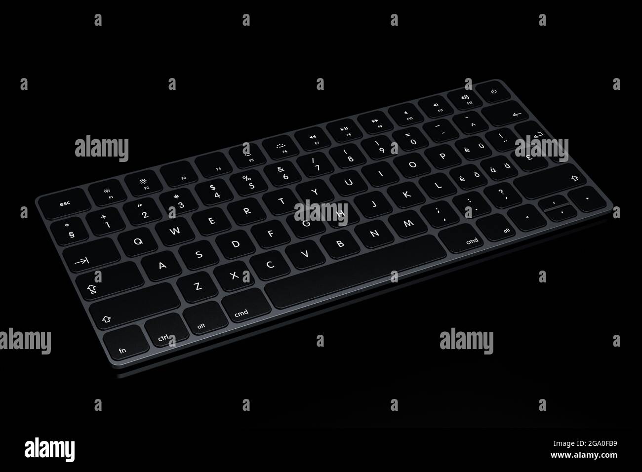 Modern dark aluminum computer keyboard isolated on black background ...