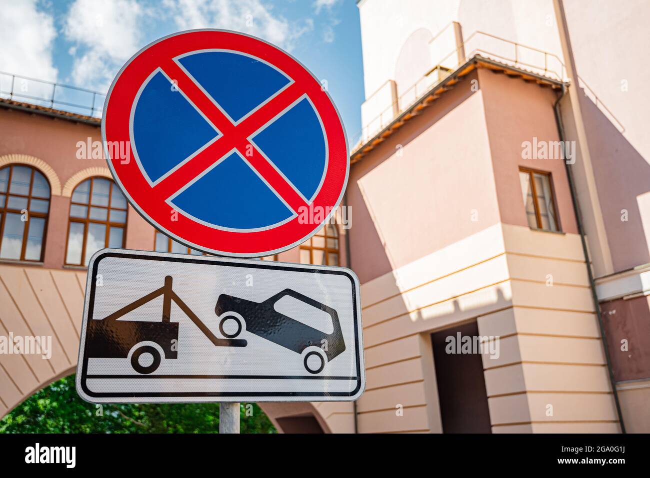 Road signs Stopping prohibited and Tow truck is working Stock Photo - Alamy