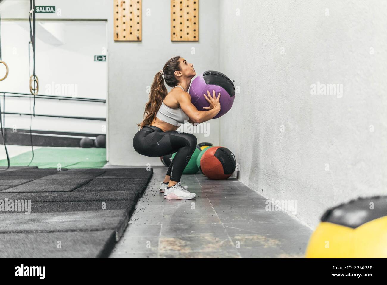 Woman and squat exercise and wall hi-res stock photography and images ...