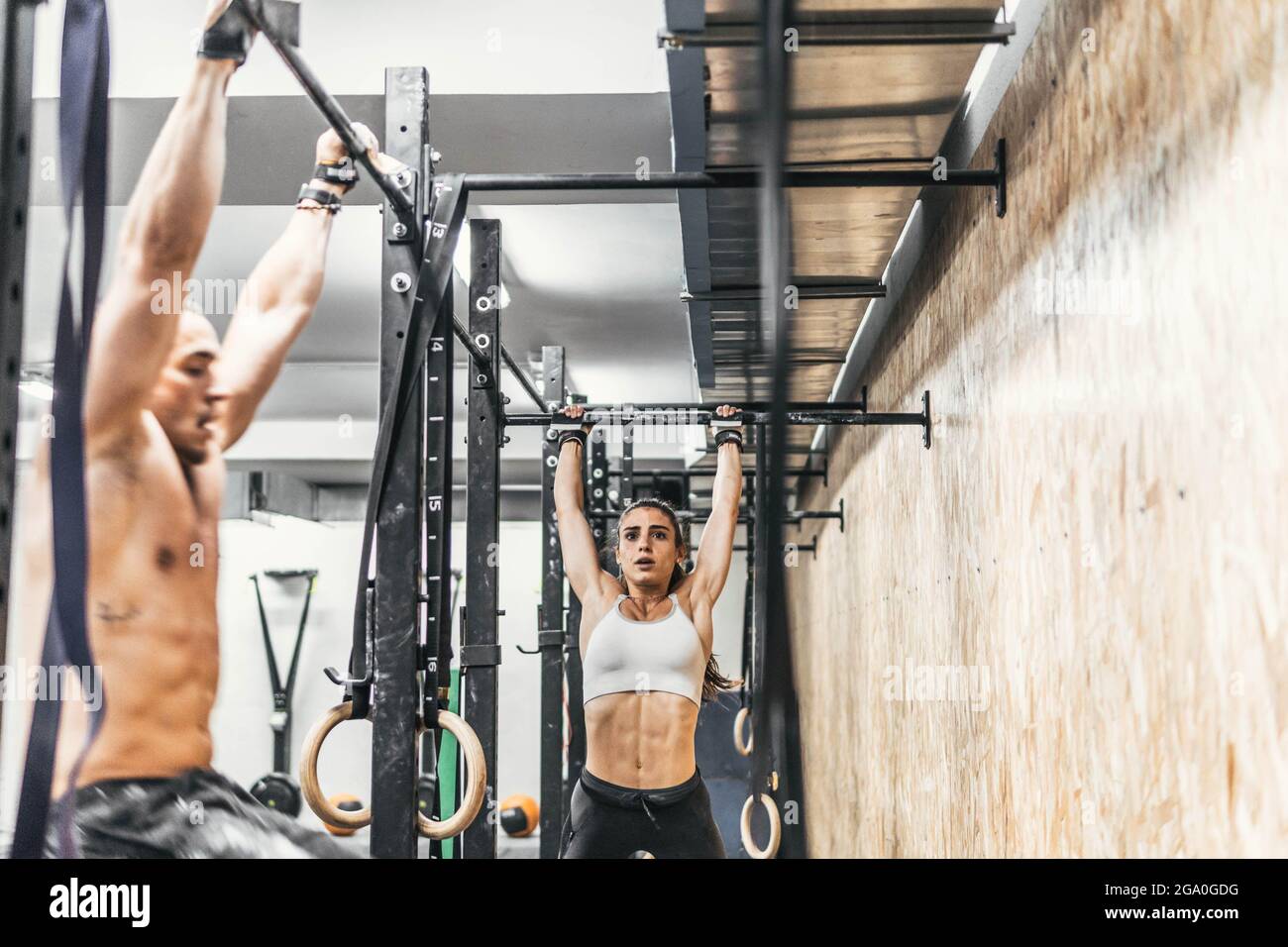 woman and man hanging on the bar doing push-ups, crossfit Stock Photo ...