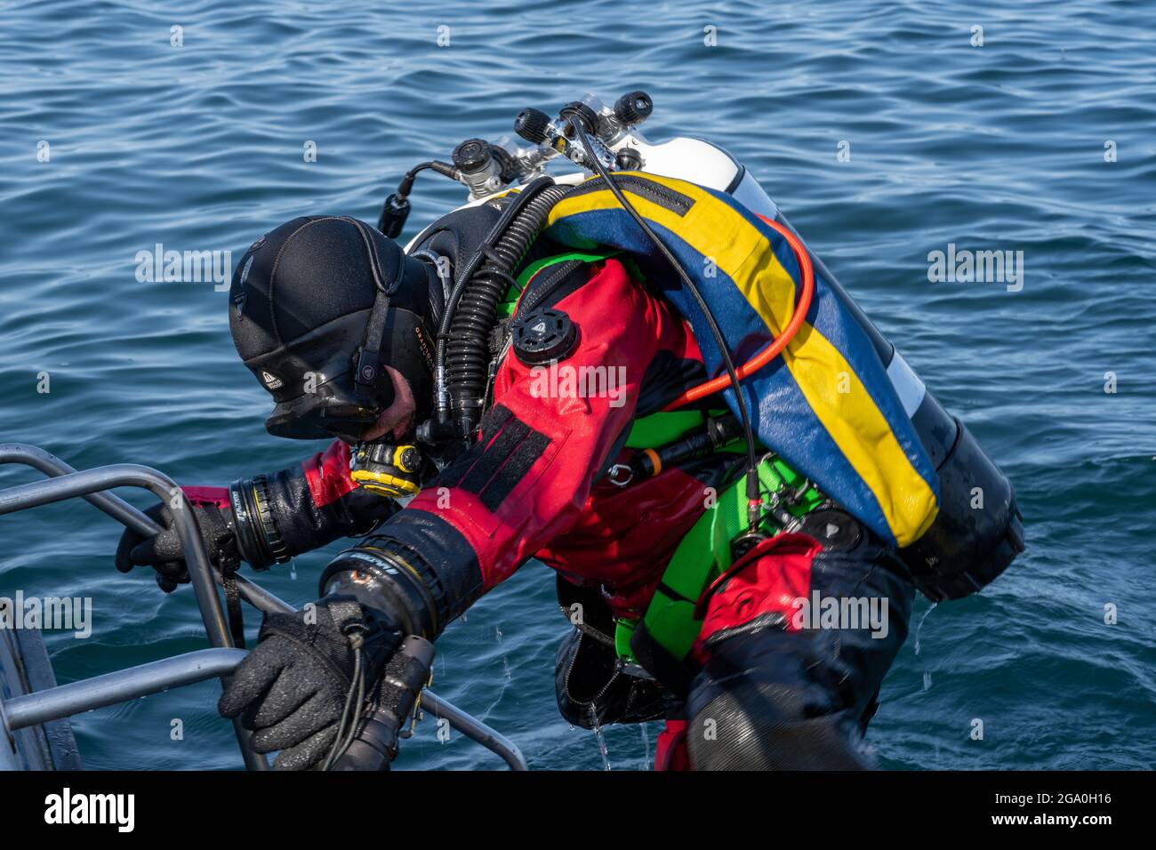 April 17, 2021 - Hamburgsund, Sweden: A scuba diver climbing the ladder ...
