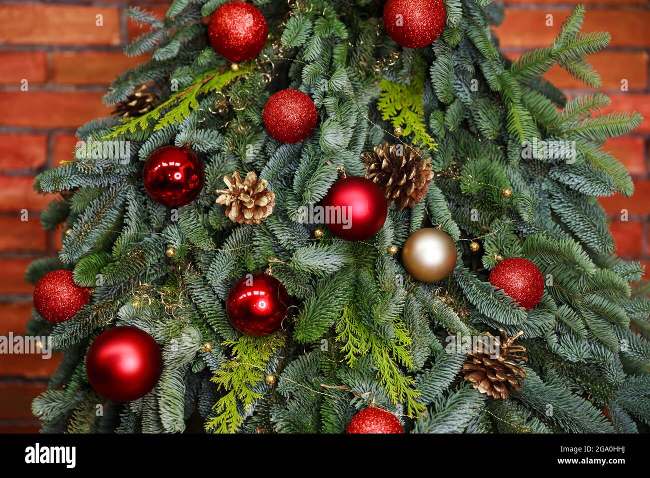 New Year tree made of fir decorated with flowers, garland and balls ...
