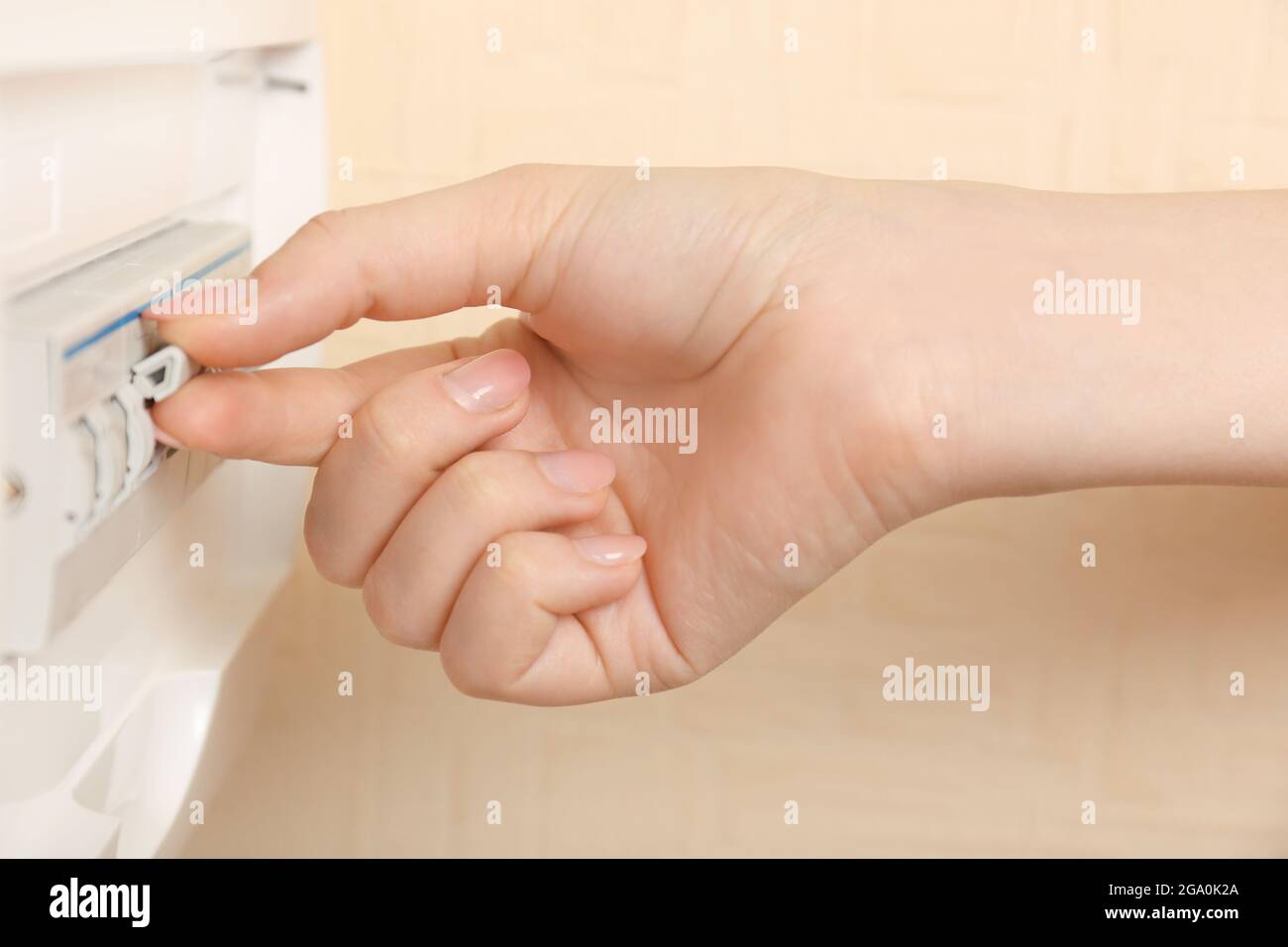 Woman turning off fuse box close up Stock Photo - Alamy