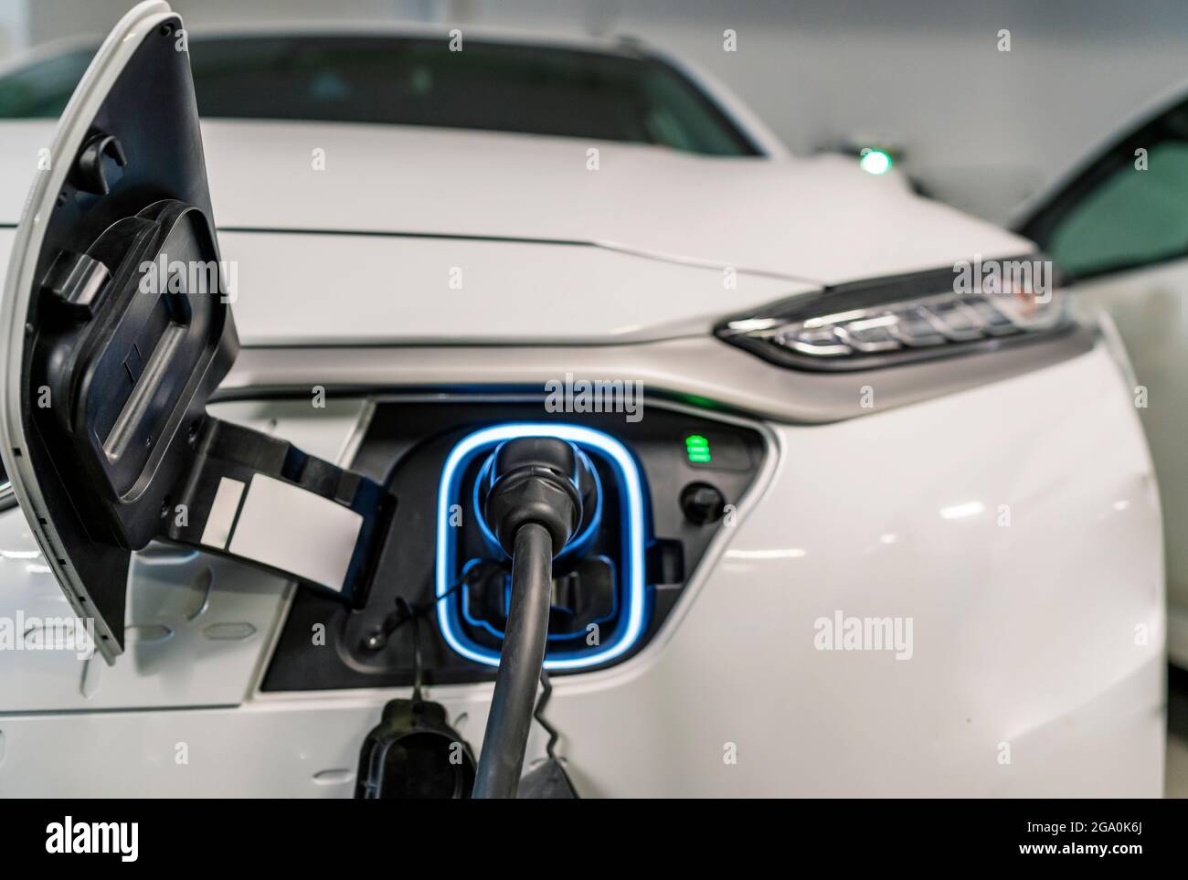 white electric vehicle in charge Stock Photo - Alamy