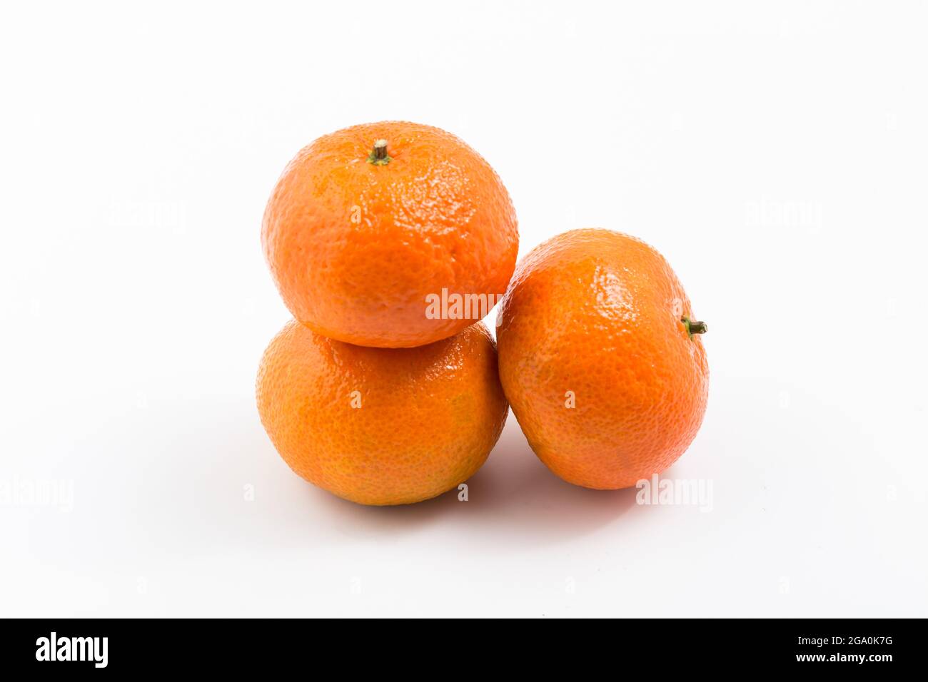 three tangerines on white background Stock Photo - Alamy