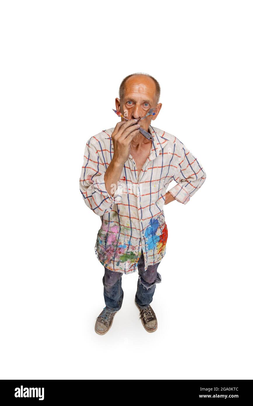 Mature or senior grey painter with a brush standing in front of camera ...