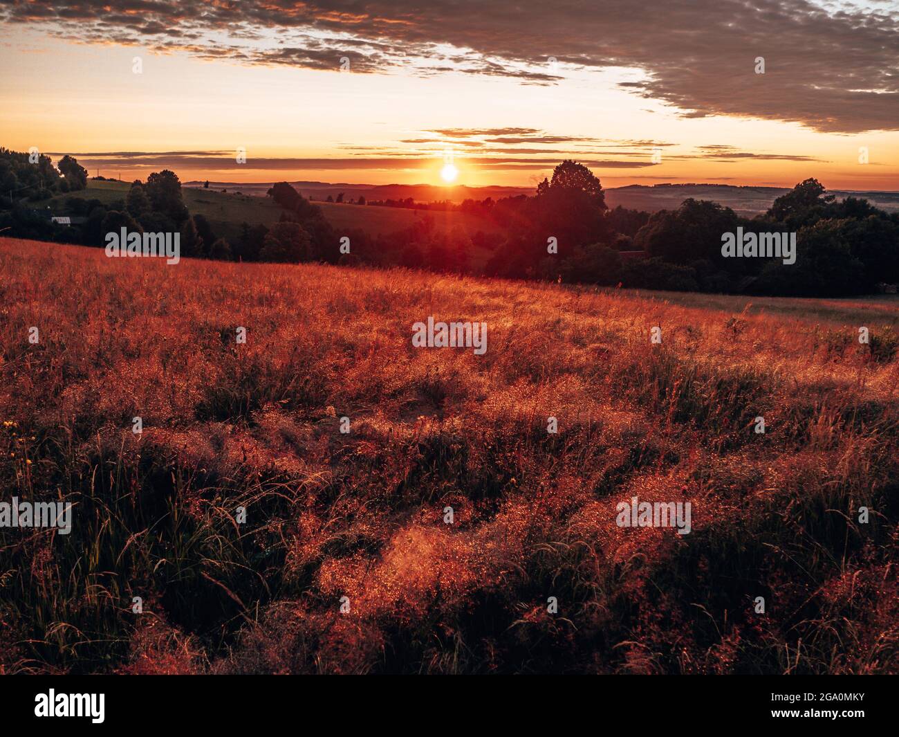 Horizontal photo showing a late sunset on the hills of the Jizera ...