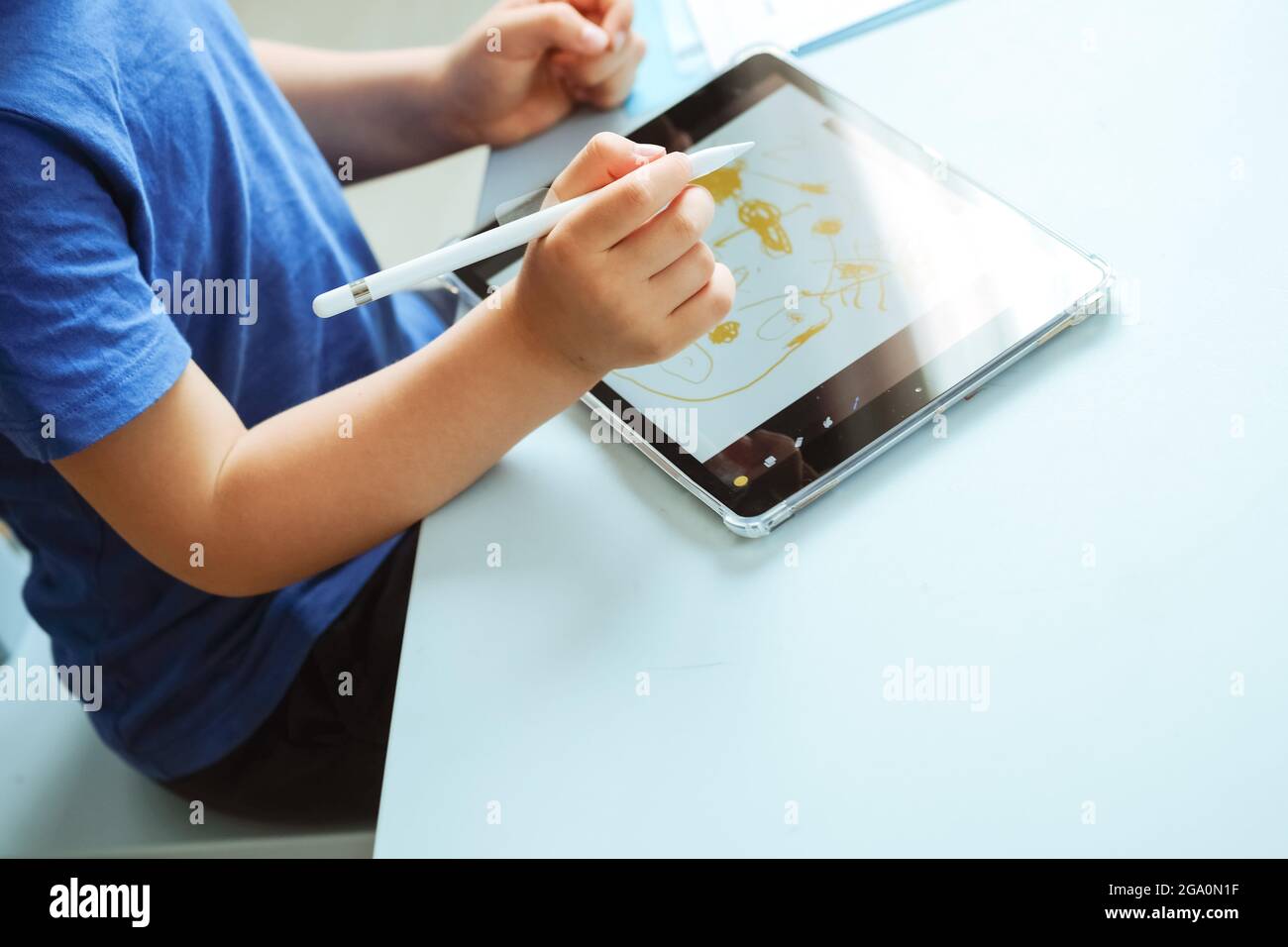 Hands of Children drawing with digital pen on the tablet, image with ...