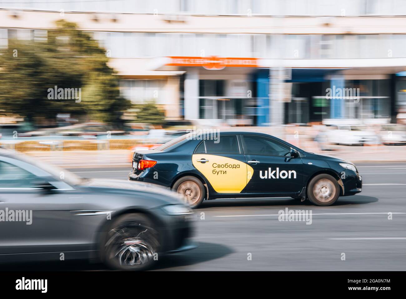 Ukraine, Kyiv - 16 July 2021: Black Geely MK Taxi Uklon car moving on ...