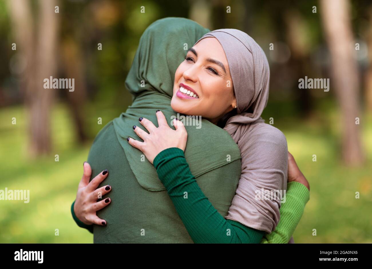 Two Multiracial Islamic Ladies Hugging Posing Standing Outdoors Stock ...