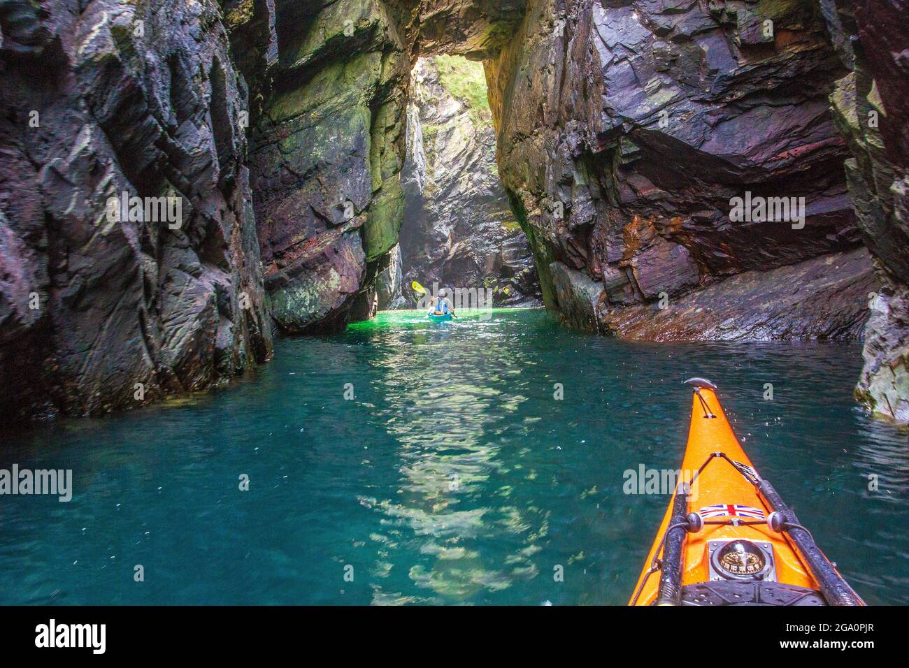Exploring sea caves whilst Sea kayaking off the coast of Anglesey ...
