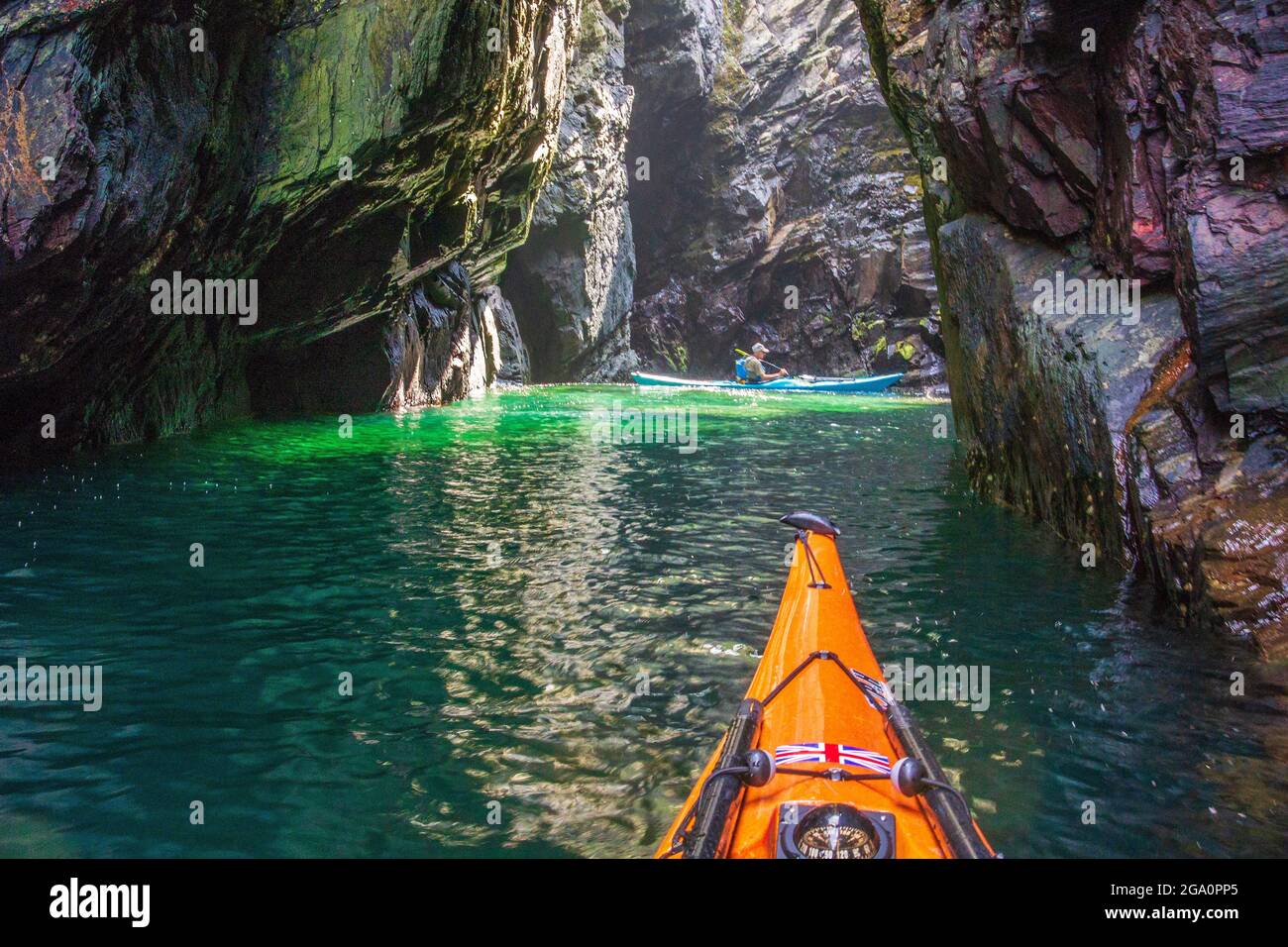 Exploring sea caves whilst Sea kayaking off the coast of Anglesey ...