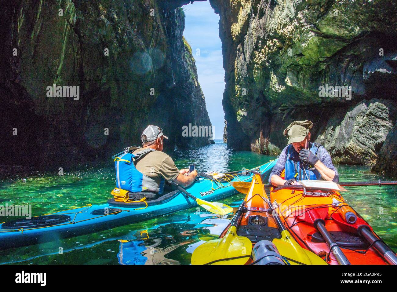 Exploring sea caves whilst Sea kayaking off the coast of Anglesey ...