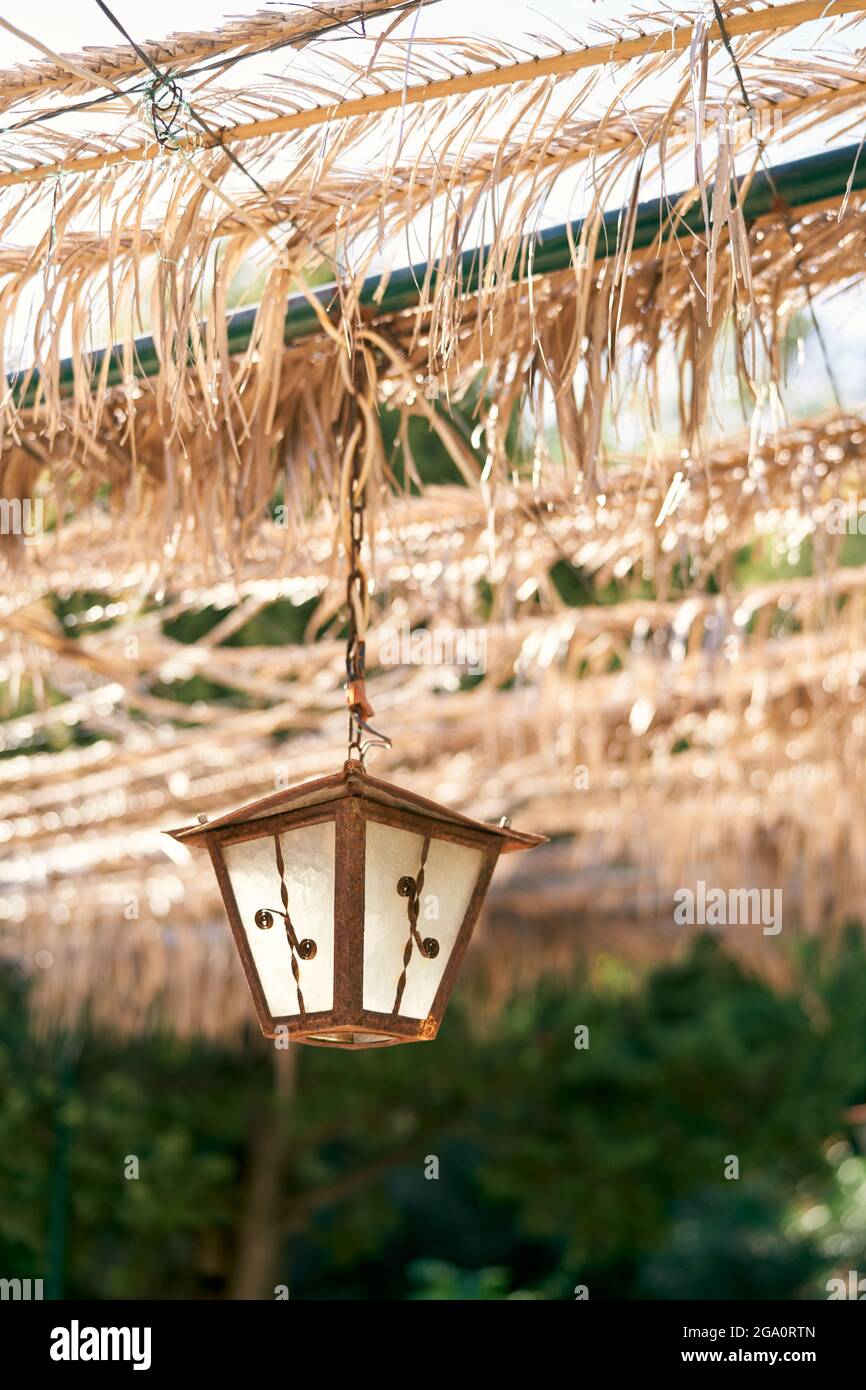 Beautiful rustic lantern on a chain hanging on a canopy Stock Photo - Alamy
