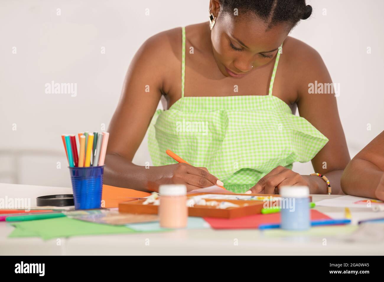 Teacher helping to student to drawing in school activity Stock Photo ...