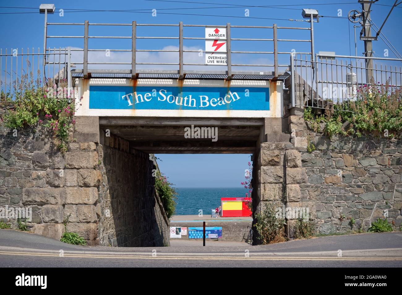 GREYSTONES, IRELAND - Jul 02, 2021: Railway bridge with an entrance to ...