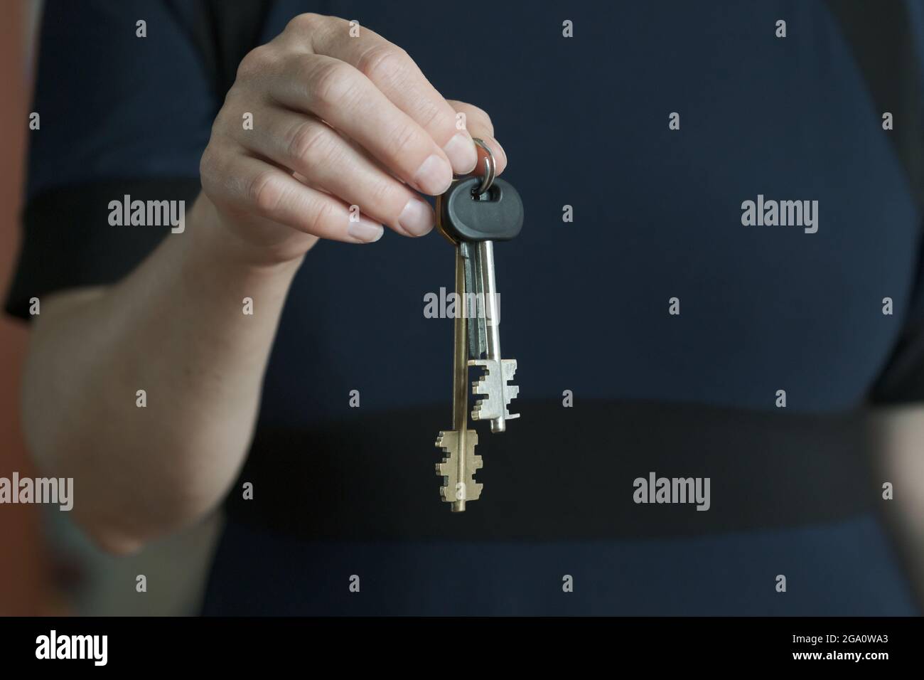 The hand holds the key from the door lock Stock Photo - Alamy